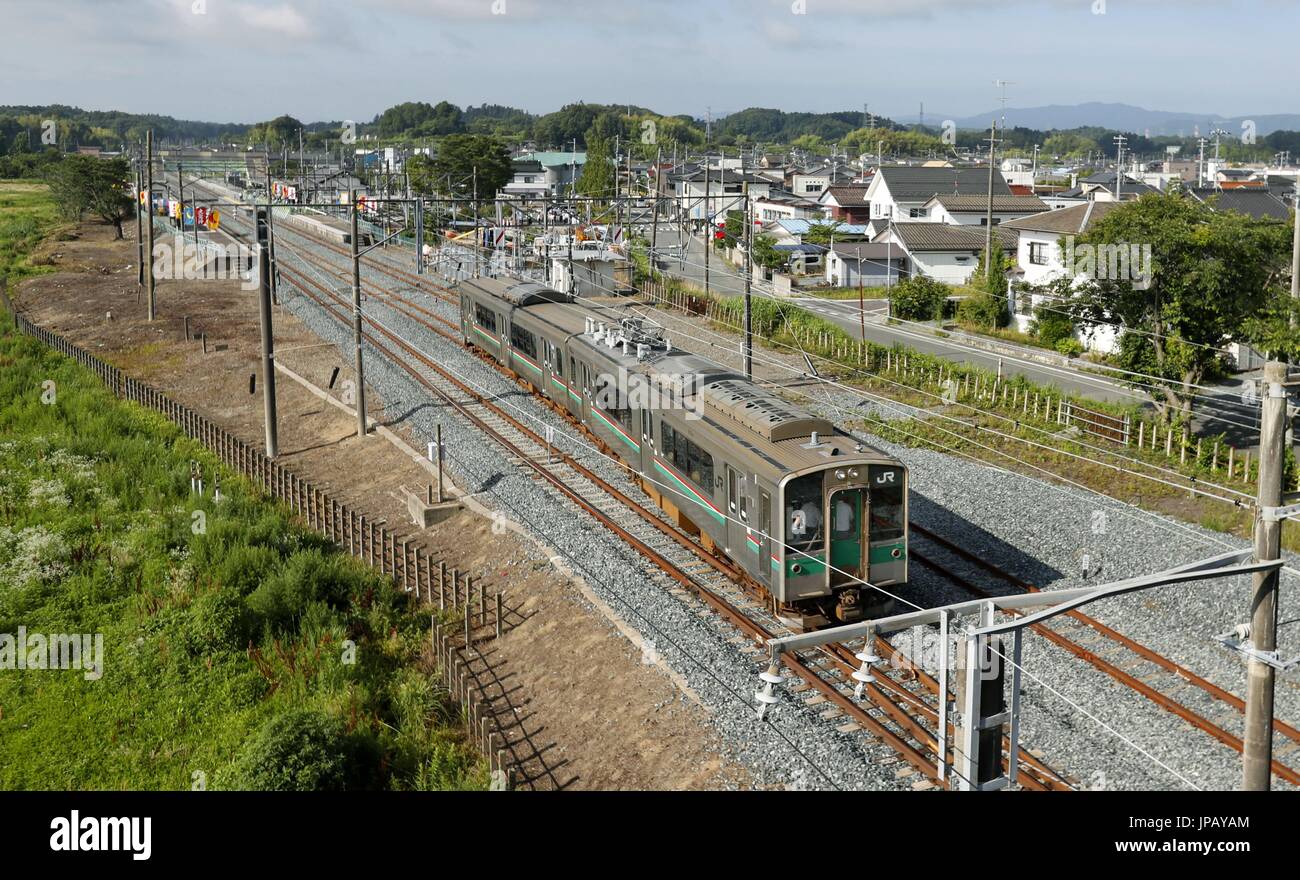 Photo taken July 12, 2016, shows a train running between two stations ...
