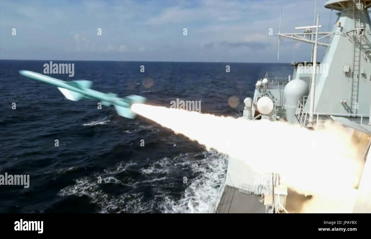 A Chinese navy vessel takes part in military drills in waters near the ...
