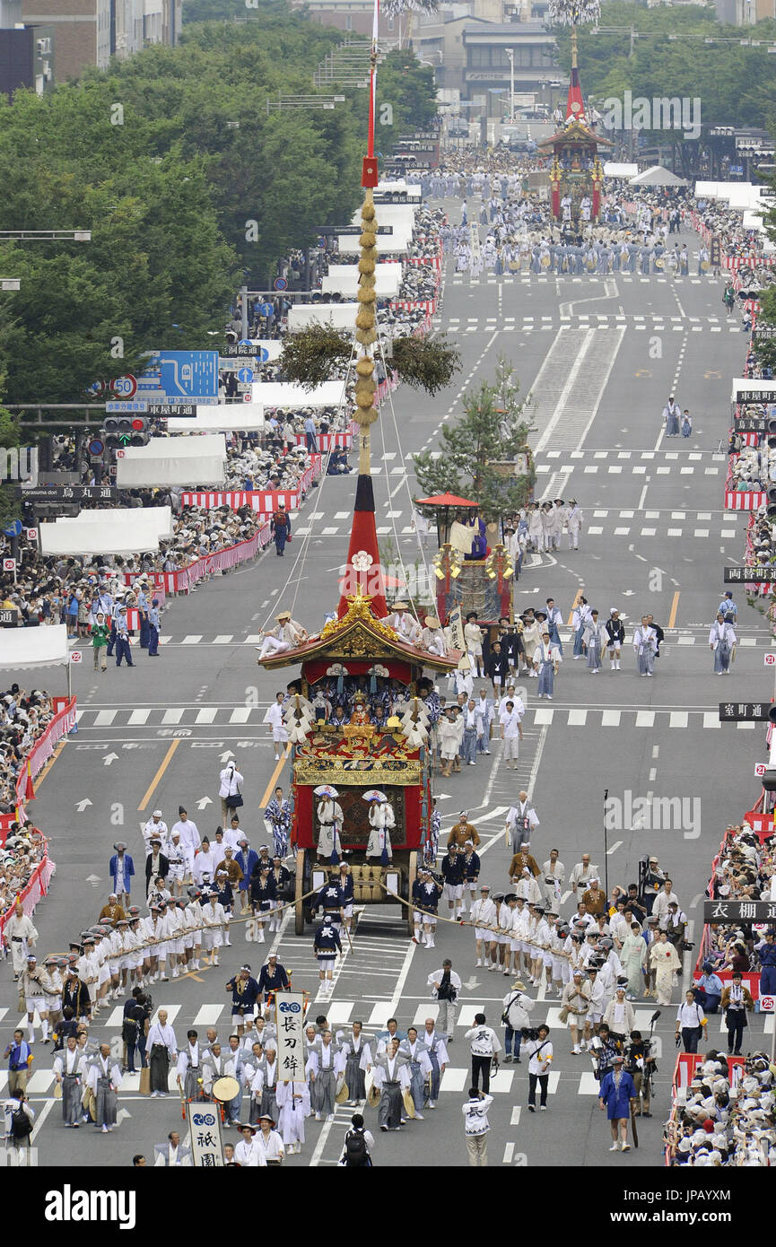 A procession of 23 decorated floats parades down Oike Street in Kyoto ...