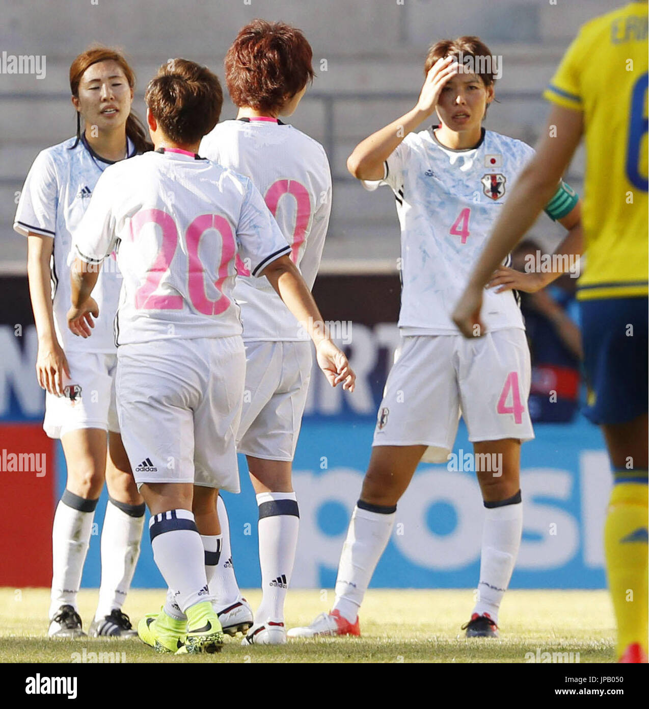 Members of the Japanese women's soccer team are seen after succumbing ...