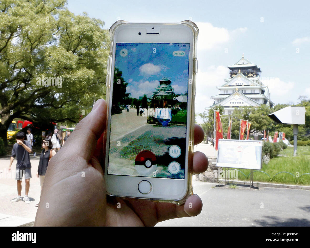 A mobile phone screen shows Osaka Castle on July 22, 2016, the debut ...