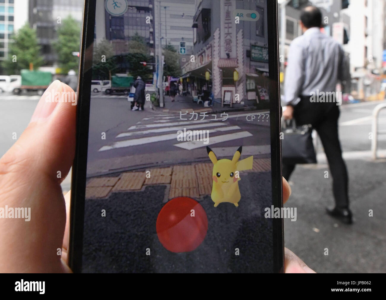 Pikachu appears on a mobile phone screen as a user plays the smash-hit ...