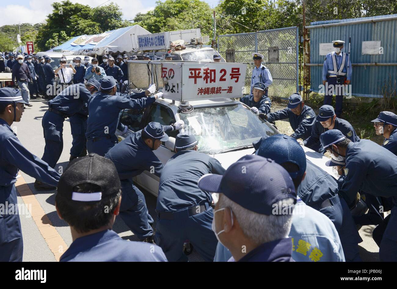 Riot police remove a vehicle that was parked to obstruct the entry of ...