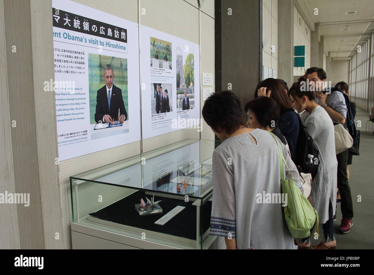 Visitors to the Hiroshima Peace Memorial Museum on June 30, 2016, see ...