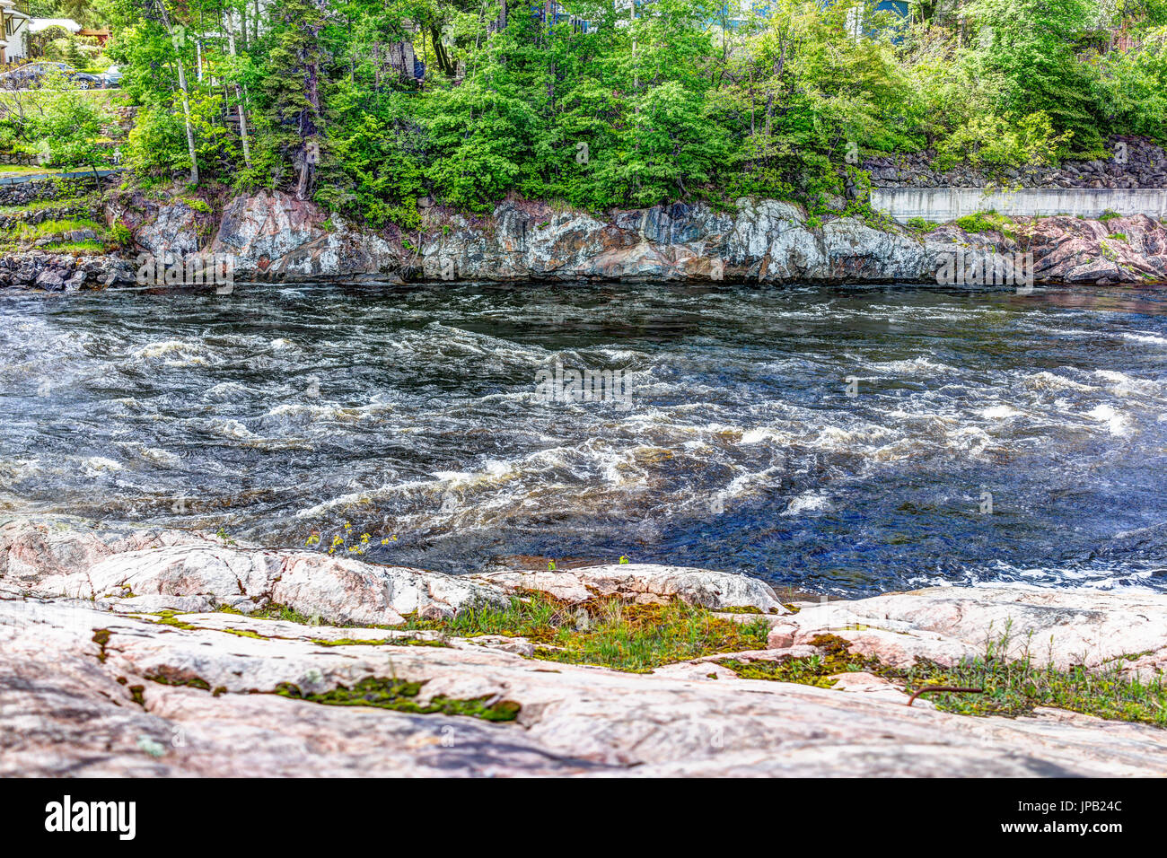 Chicoutimi river in Quebec, Canada with water flowing in summer by ...