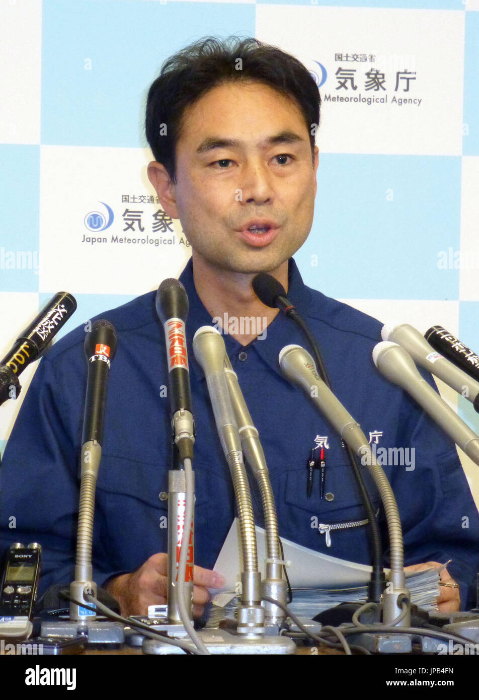 Gen Aoki, an official of the Japan Meteorological Agency, attends a ...