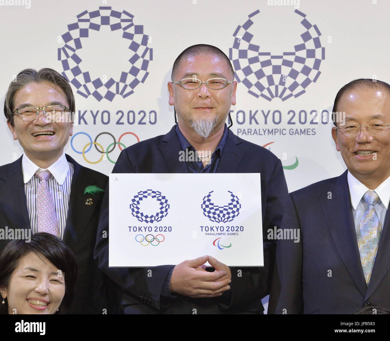 Tokyo-based artist Asao Tokolo (C) poses for photos with his navy ...