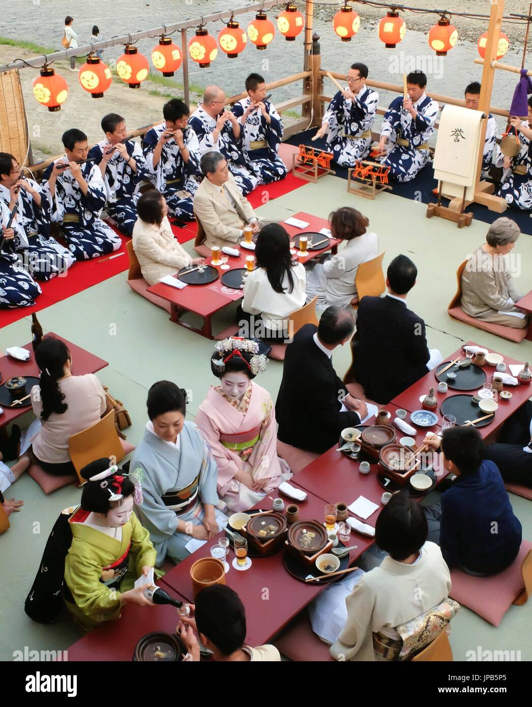 Visitors enjoy a traditional musical performance at a restaurant on a ...