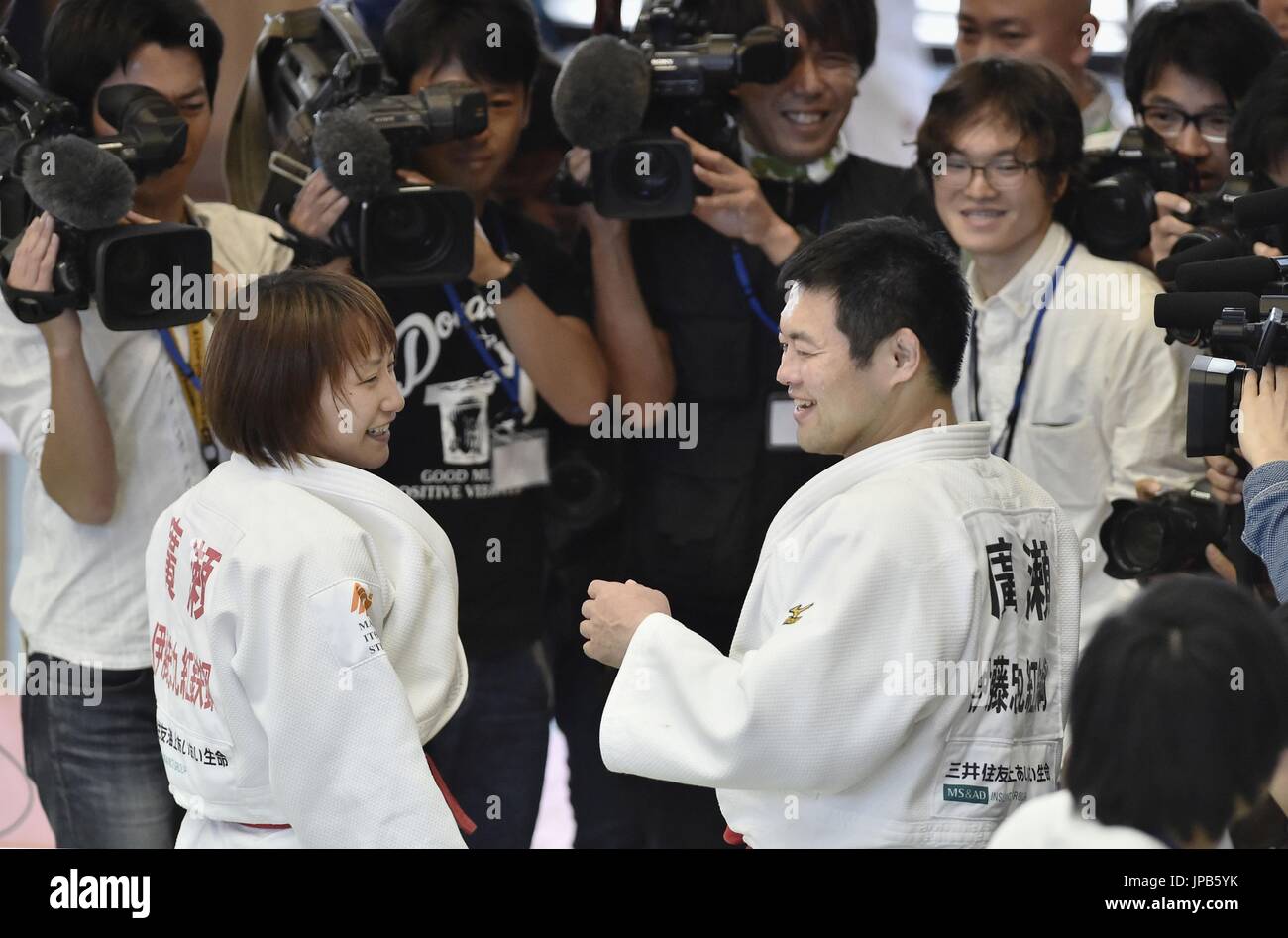 Visually impaired judo player Junko Hirose (L front) and her husband Haruka Hirose (R front) are ...