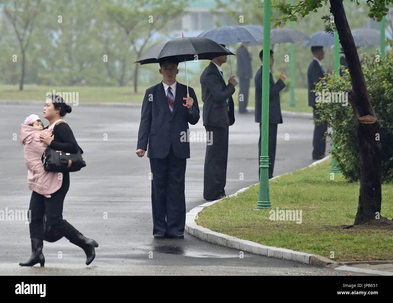 Men in suits stand guard around The April 25 House of Culture, the ...