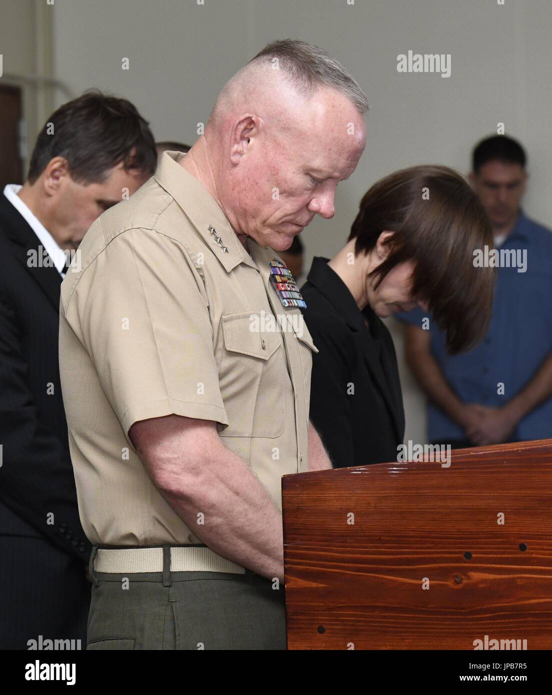 Lt. Gen. Lawrence Nicholson (C) offers a silent prayer to mourn the ...