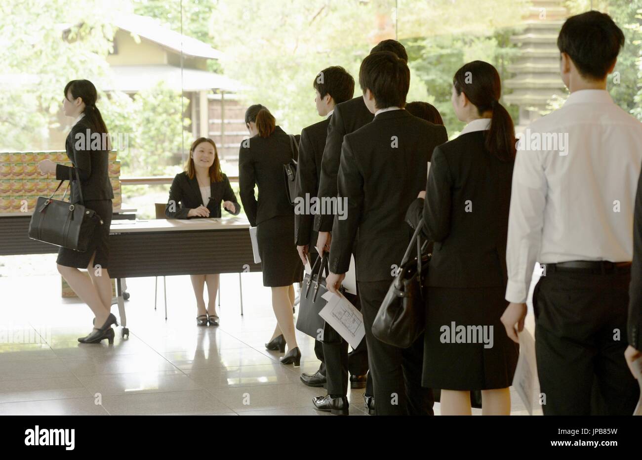 College students line up for interviews at Ajinomoto Co. in Tokyo on ...