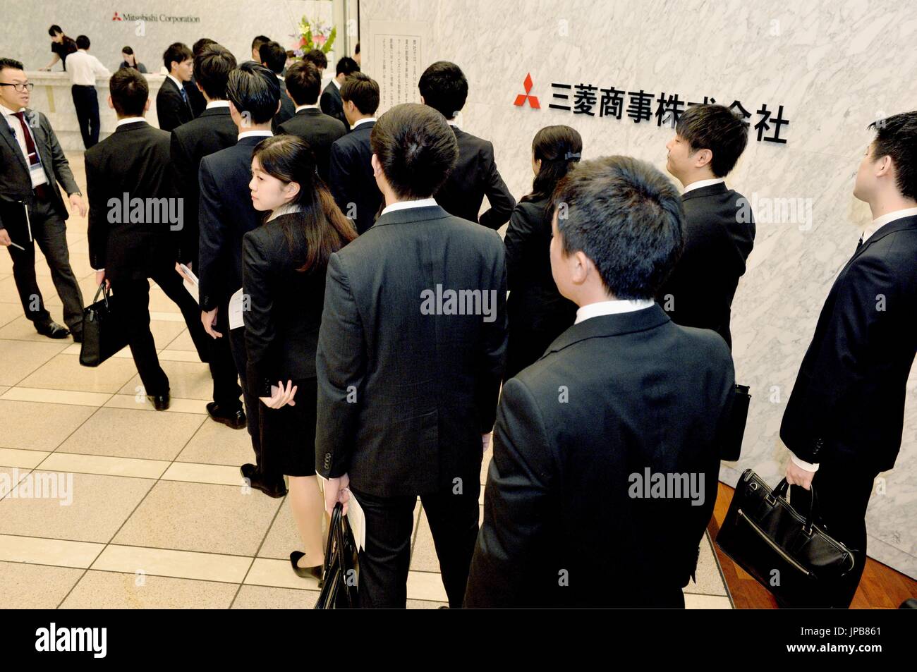 College students line up for interviews at Mitsubishi Corp. in Tokyo on ...