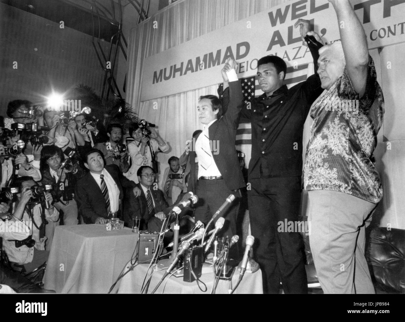 File photo taken in June 1976 shows Muhammad Ali raising his hands ...