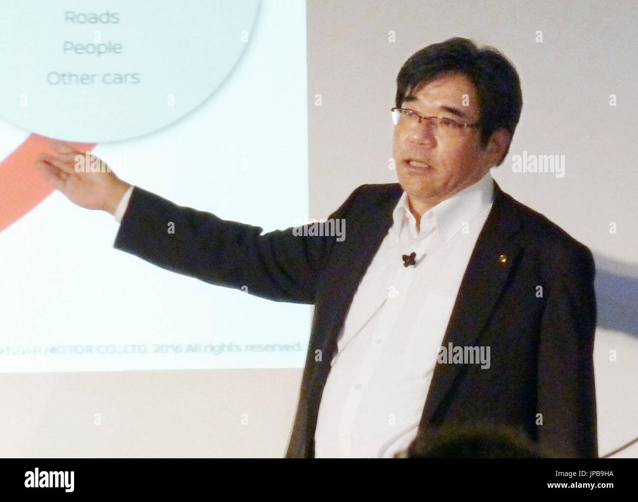 Hideyuki Sakamoto, executive vice president of Nissan Motor Co., holds ...