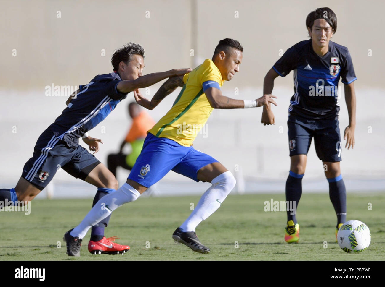 Japan's defender Sei Muroya (L) chases Brazilian striker Neymar (C ...