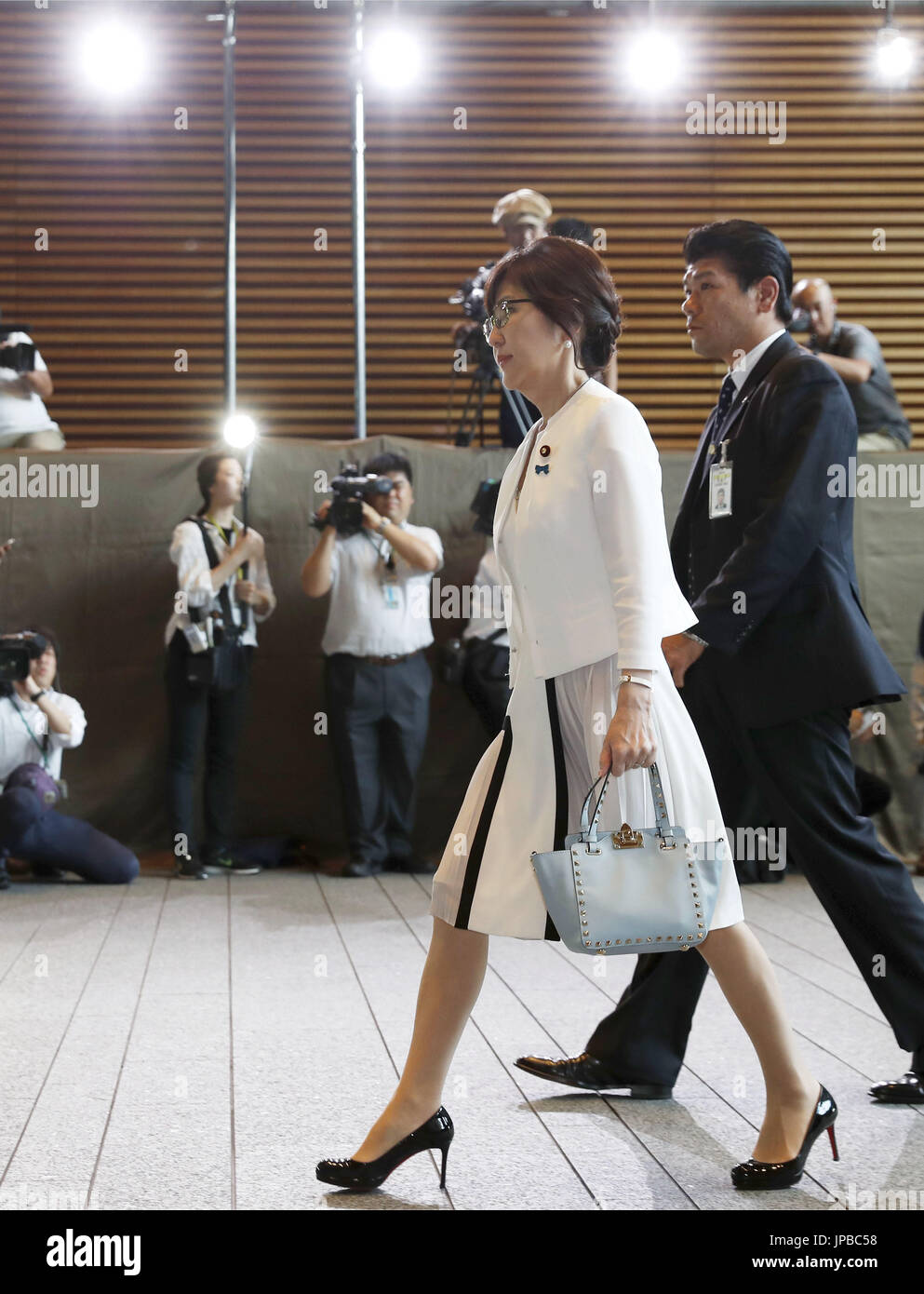 Tomomi Inada (front), newly appointed as defense minister in a Cabinet ...