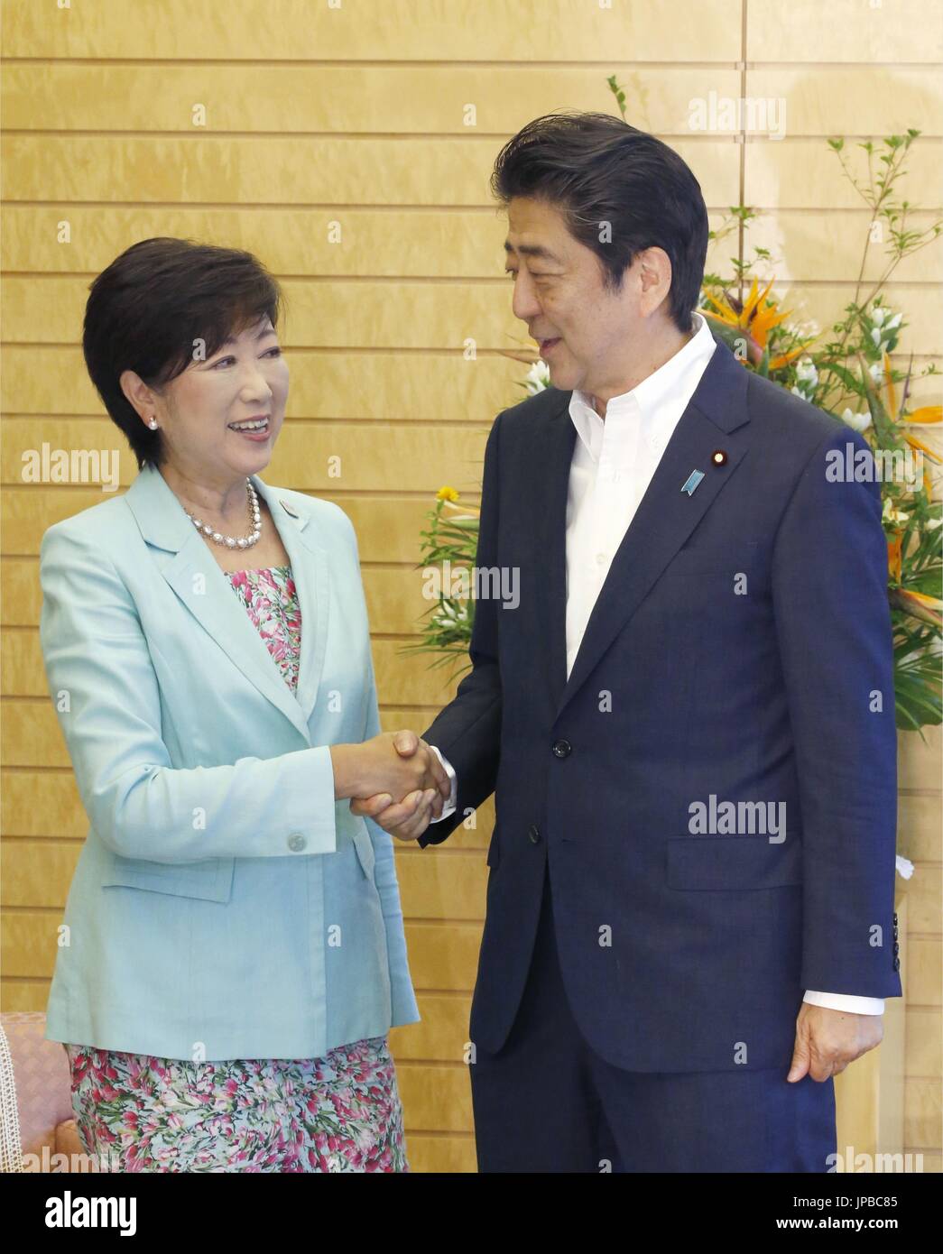 Prime Minister Shinzo Abe (R) meets with new Tokyo Gov. Yuriko Koike at ...