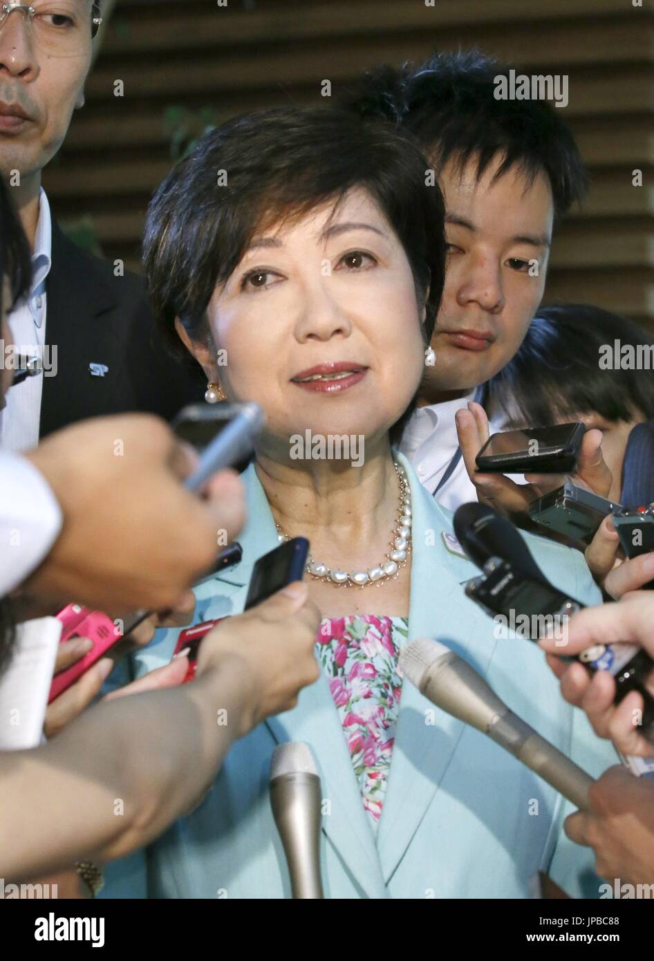 New Tokyo Gov. Yuriko Koike is surrounded by reporters after meeting ...