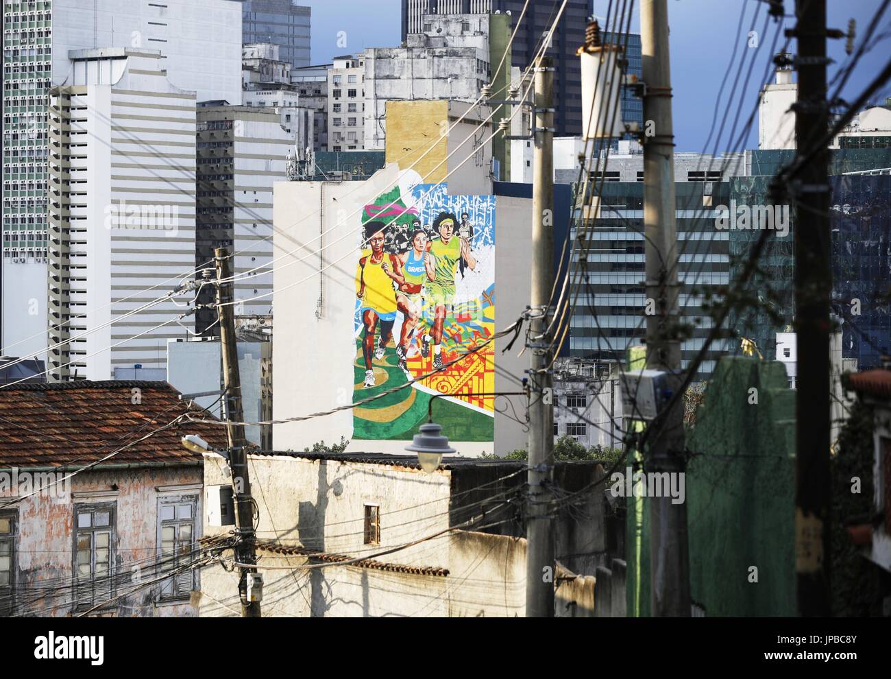 A mural of running athletes is seen painted on the exterior wall of a ...