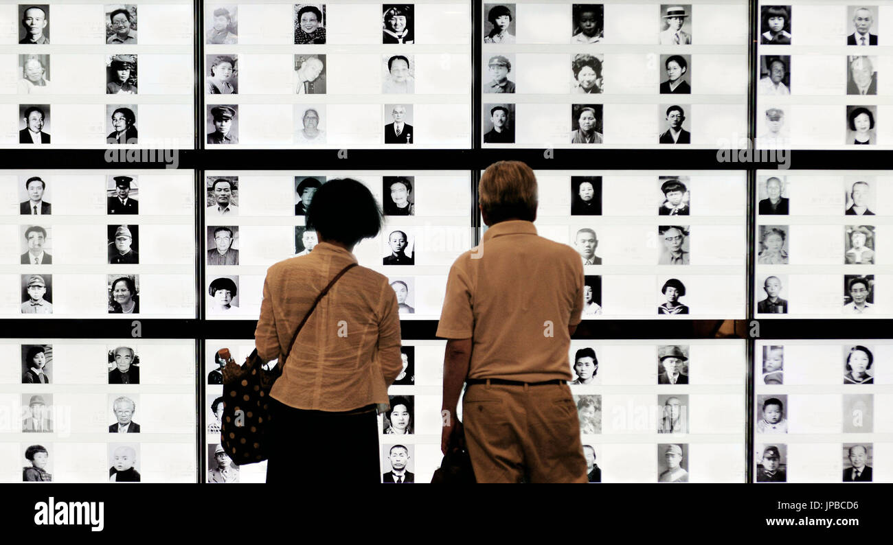 People look at photographs of those killed in the 1945 U.S. atomic ...