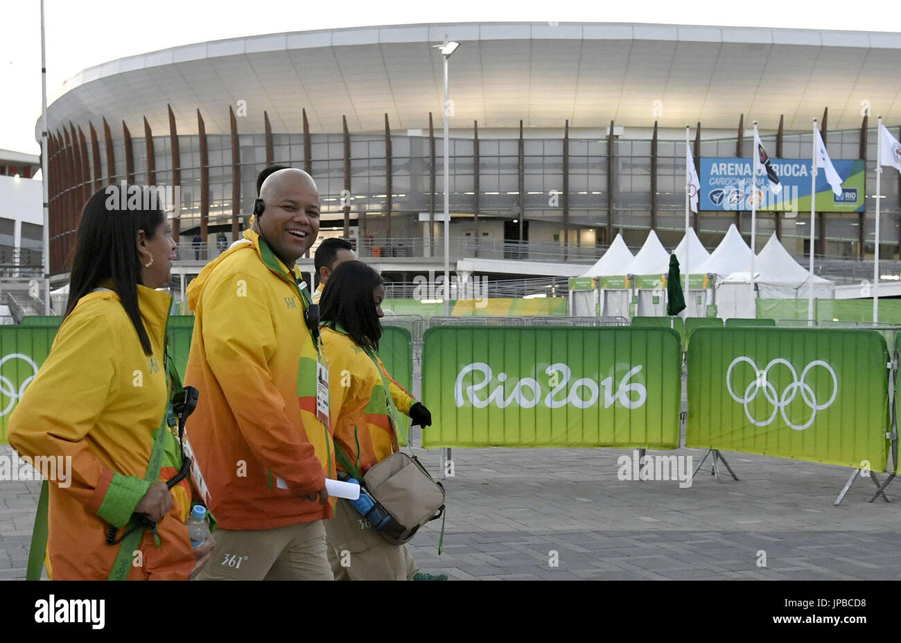 Olympic staff members shown walking in Olympic Park in Rio de Janeiro ...