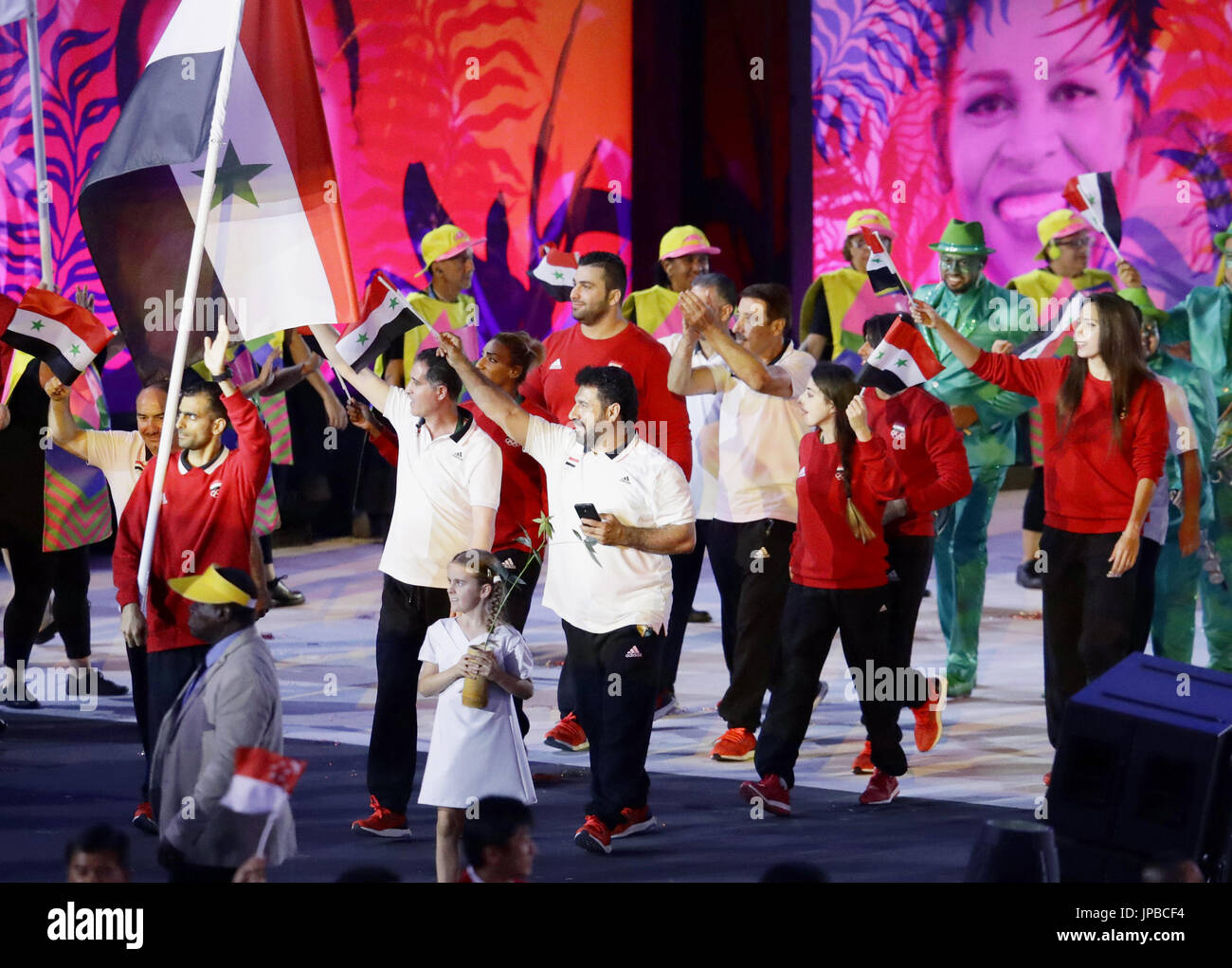 The delegation to the Rio de Janeiro Olympics from Syria enters the ...