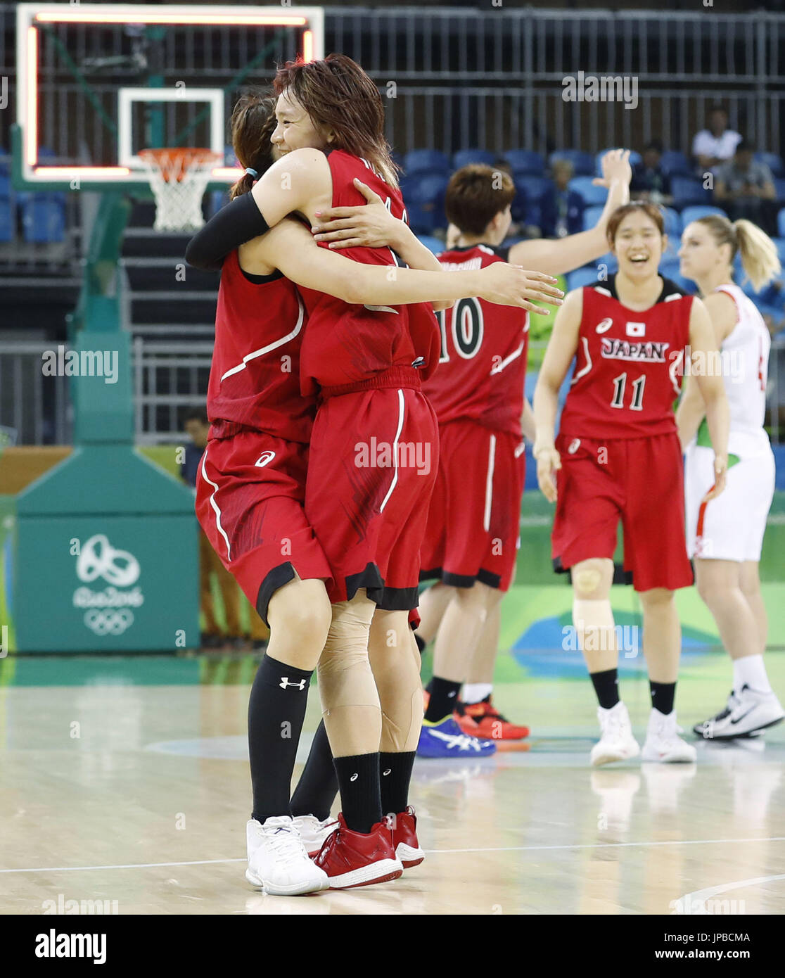 Members of the Japanese women's basketball team celebrate after winning ...