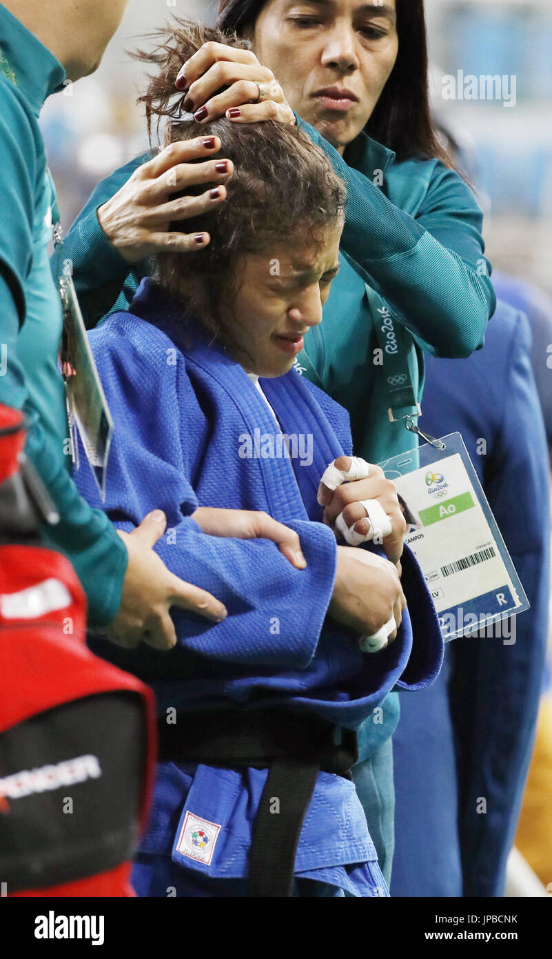 London Olympics gold medalist Sarah Menezes of Brazil (C) is consoled ...