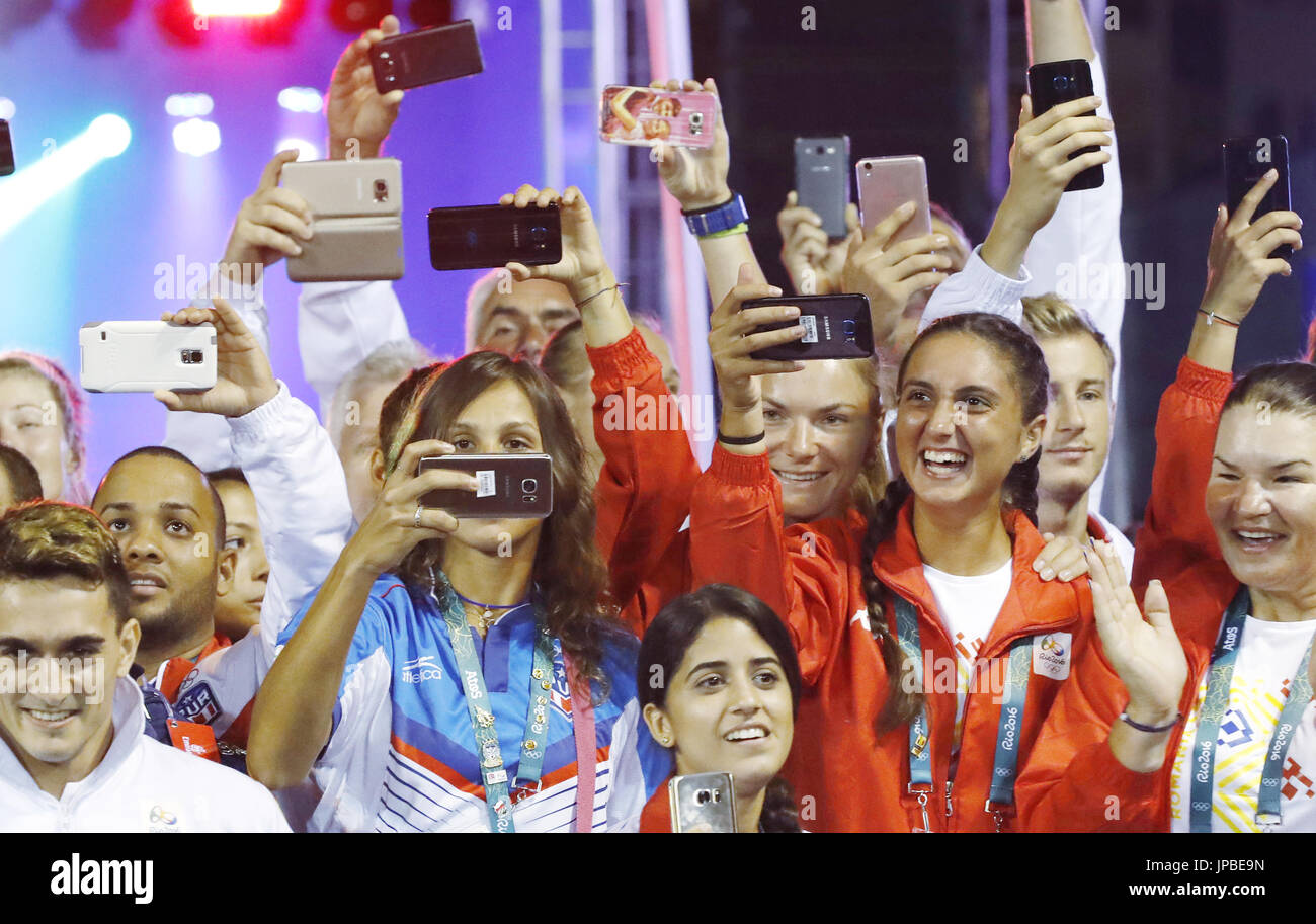 Athletes use smart phones to take photos and videos of the welcome ...