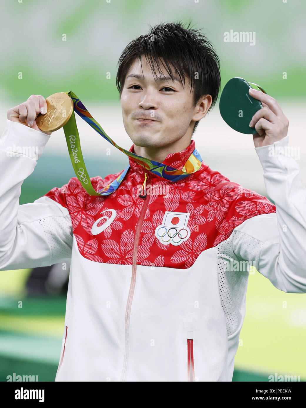 Japanese gymnast Kohei Uchimura shows off his medal after winning ...