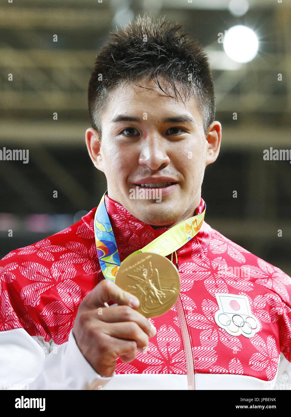 Japanese judoka Mashu Baker shows his gold medal after winning the men ...