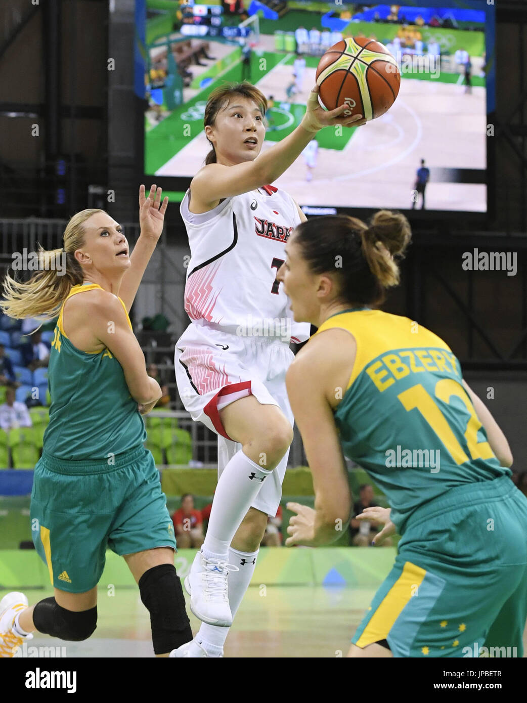 Japan's Mika Kurihara (C) drives to the basket in the first quarter of ...