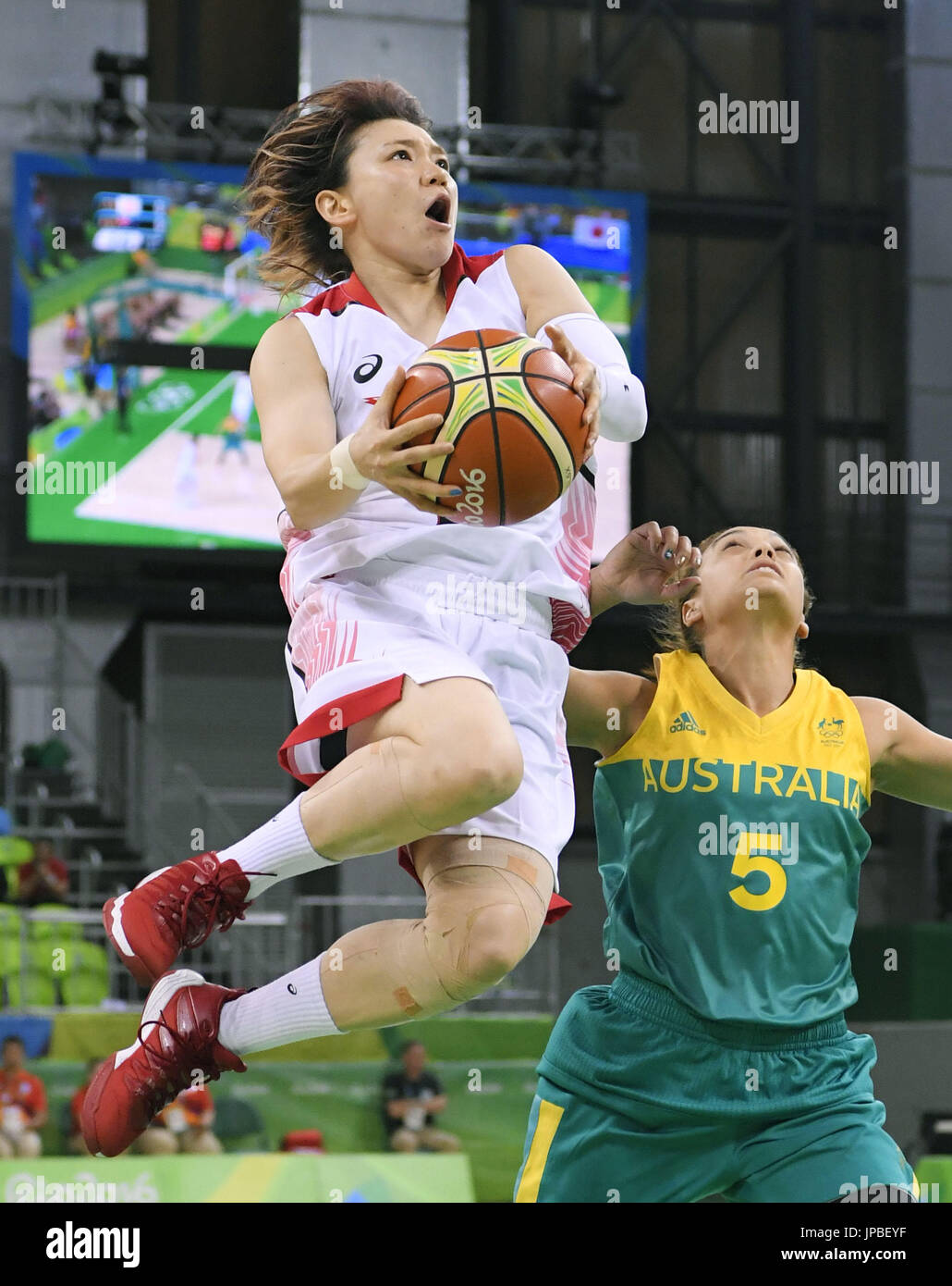 Asami Yoshida (L) of Japan drives past Australian point guard Leilani ...