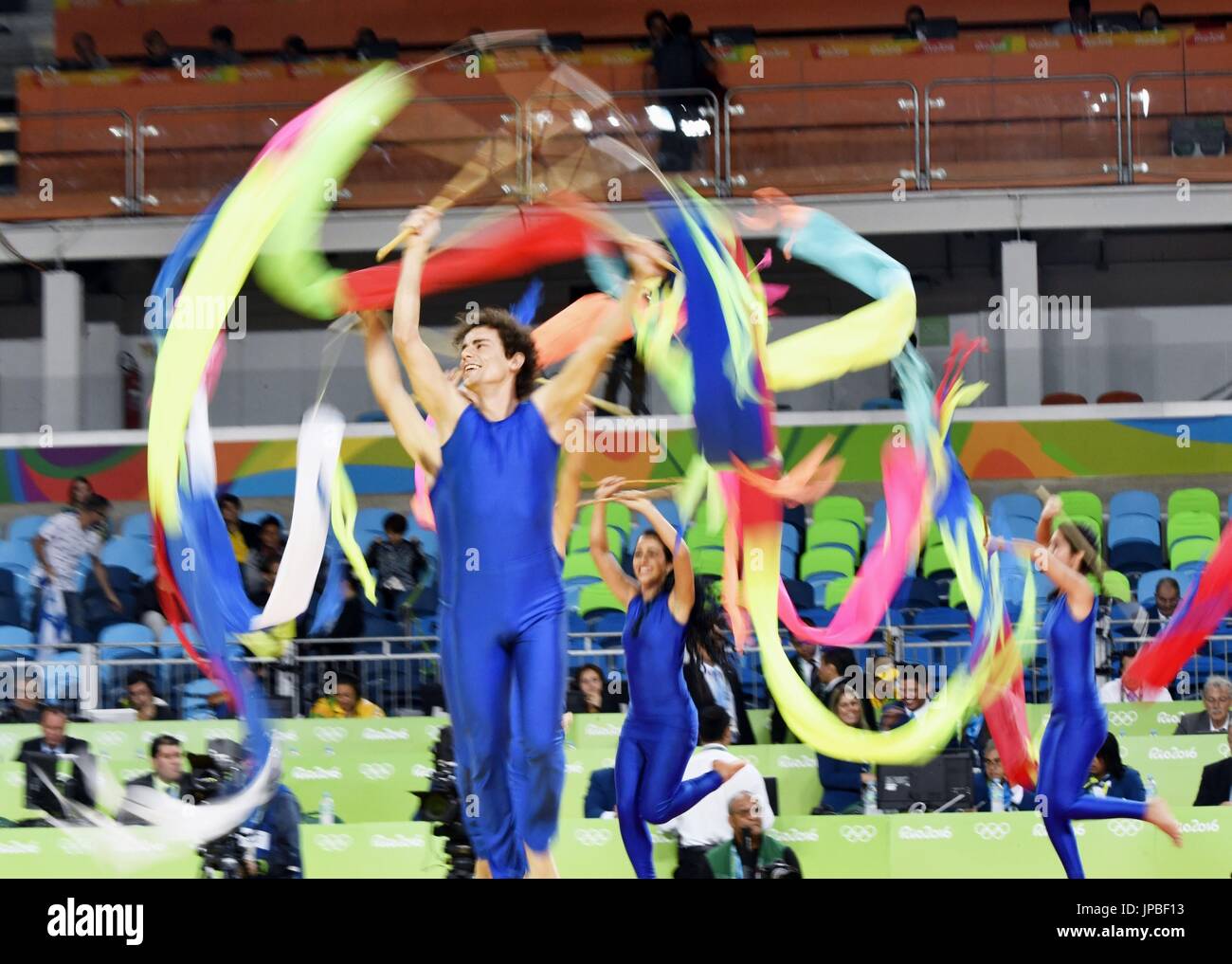 A ribbon-dance performance is staged before the start of judo matches ...