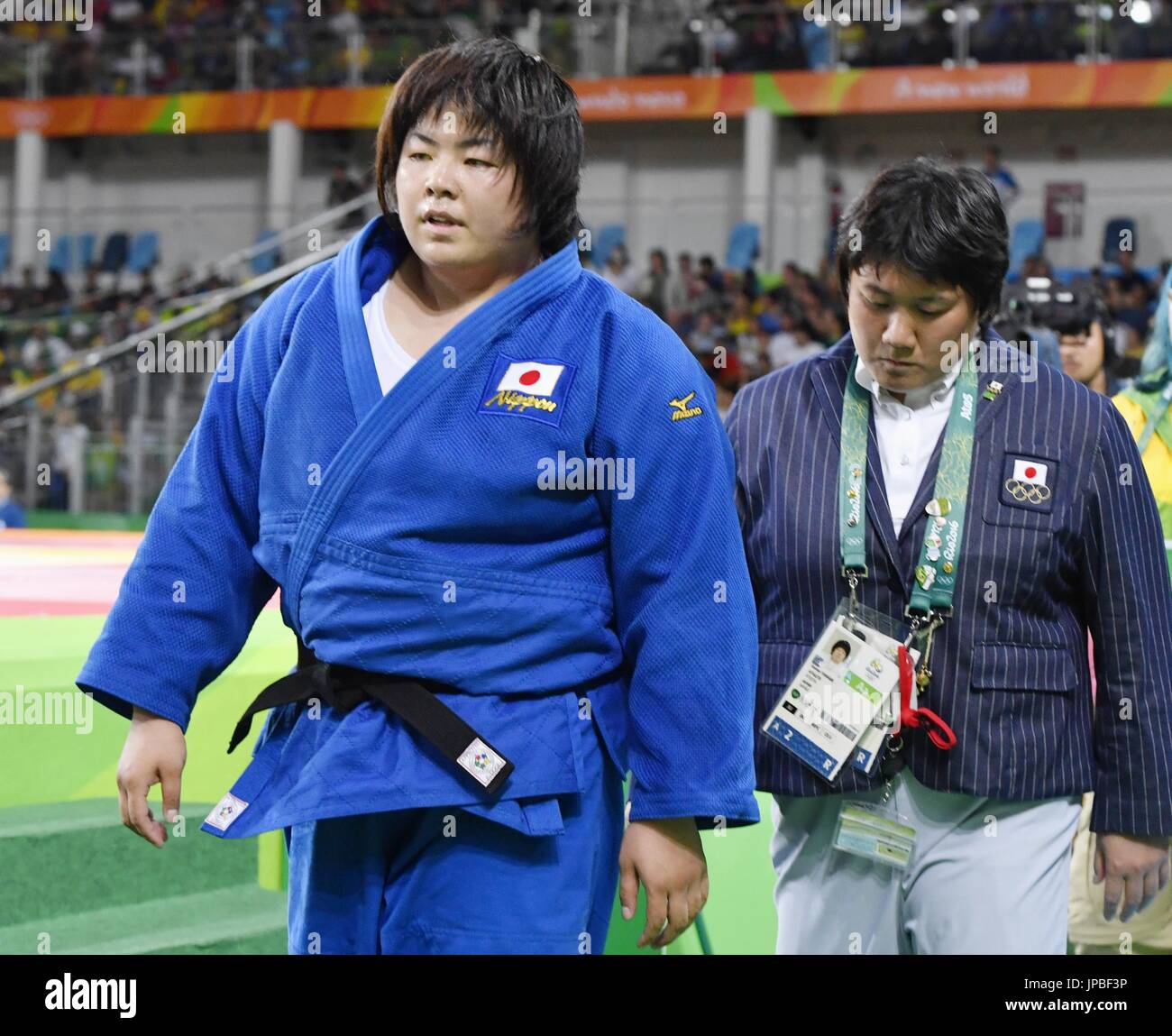 Japanese judoka Kanae Yamabe (L) leaves the mat with her coach after ...