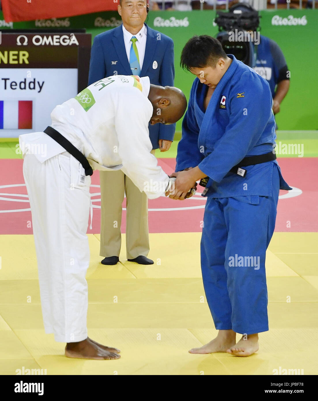 French judoka Teddy Riner (L) and Hisayoshi Harasawa of Japan shake ...
