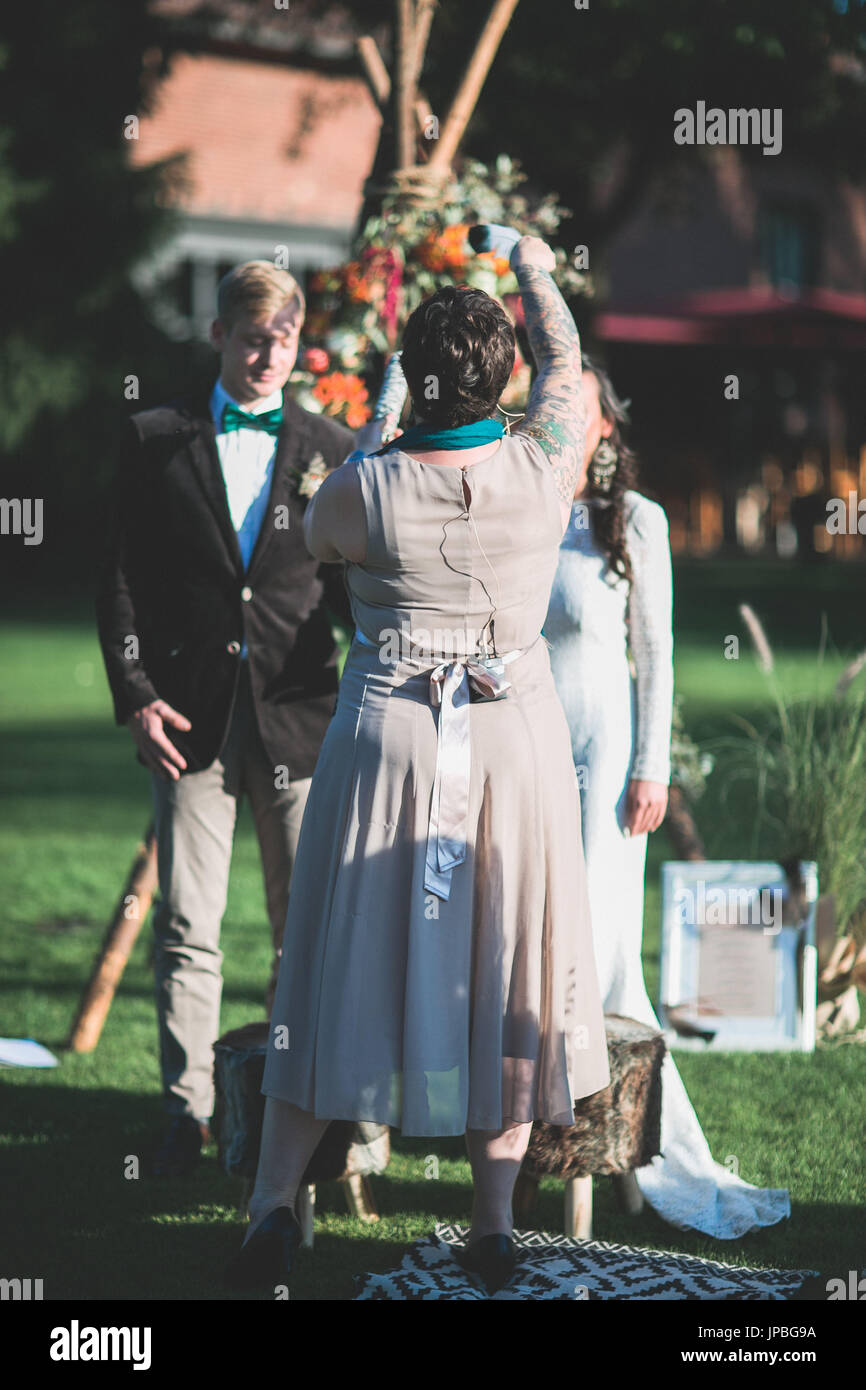 Alternate bridal couple at spiritual wedding ceremony outdoors hi-res ...
