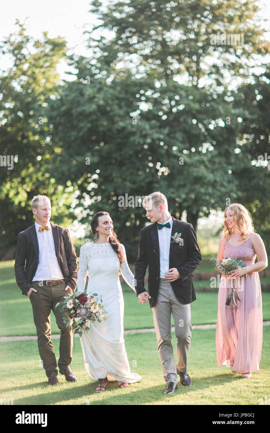 Alternate bridal couple and witness outside Stock Photo - Alamy