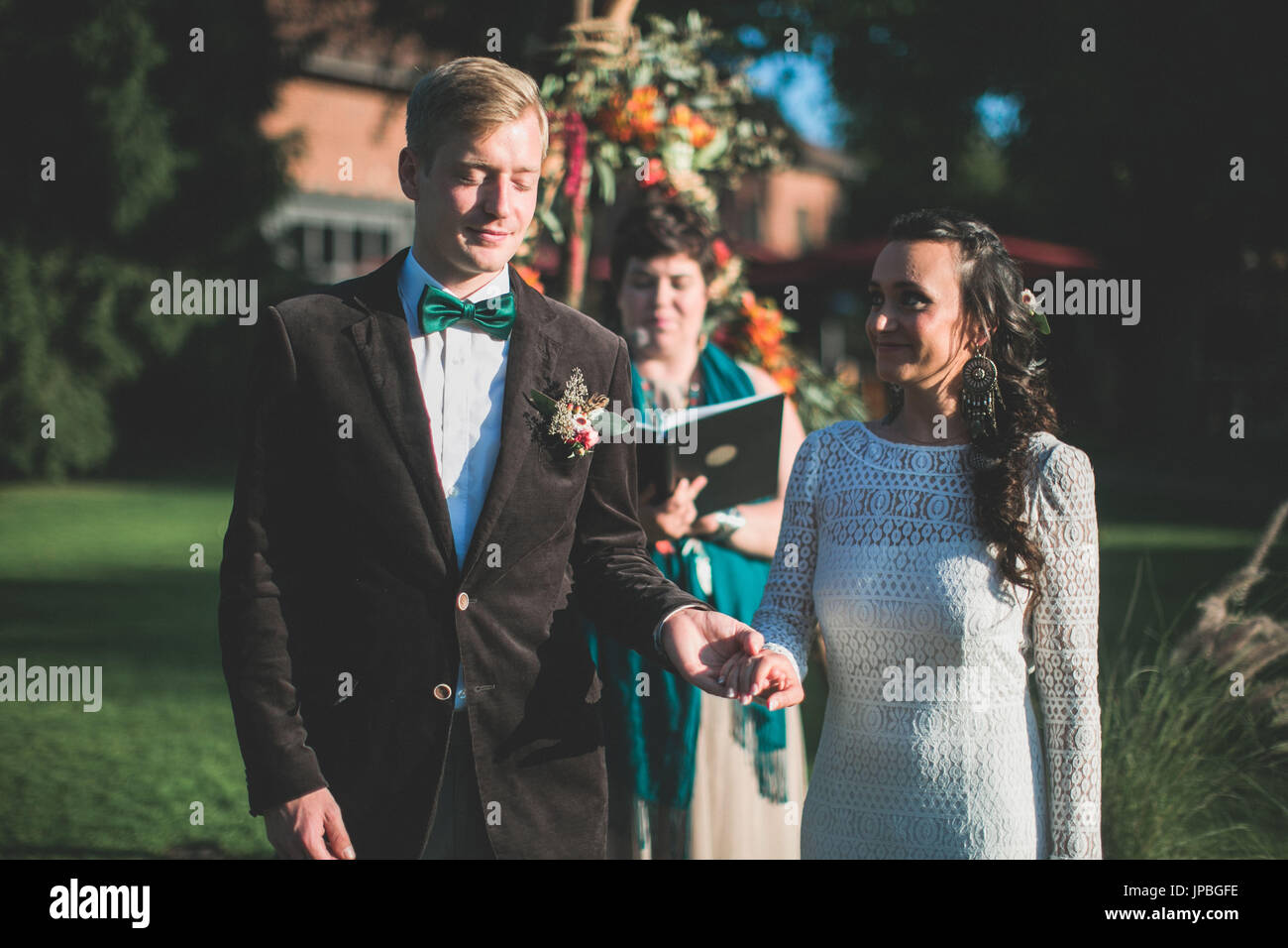 Alternate bridal couple at spiritual wedding ceremony outdoors, half ...