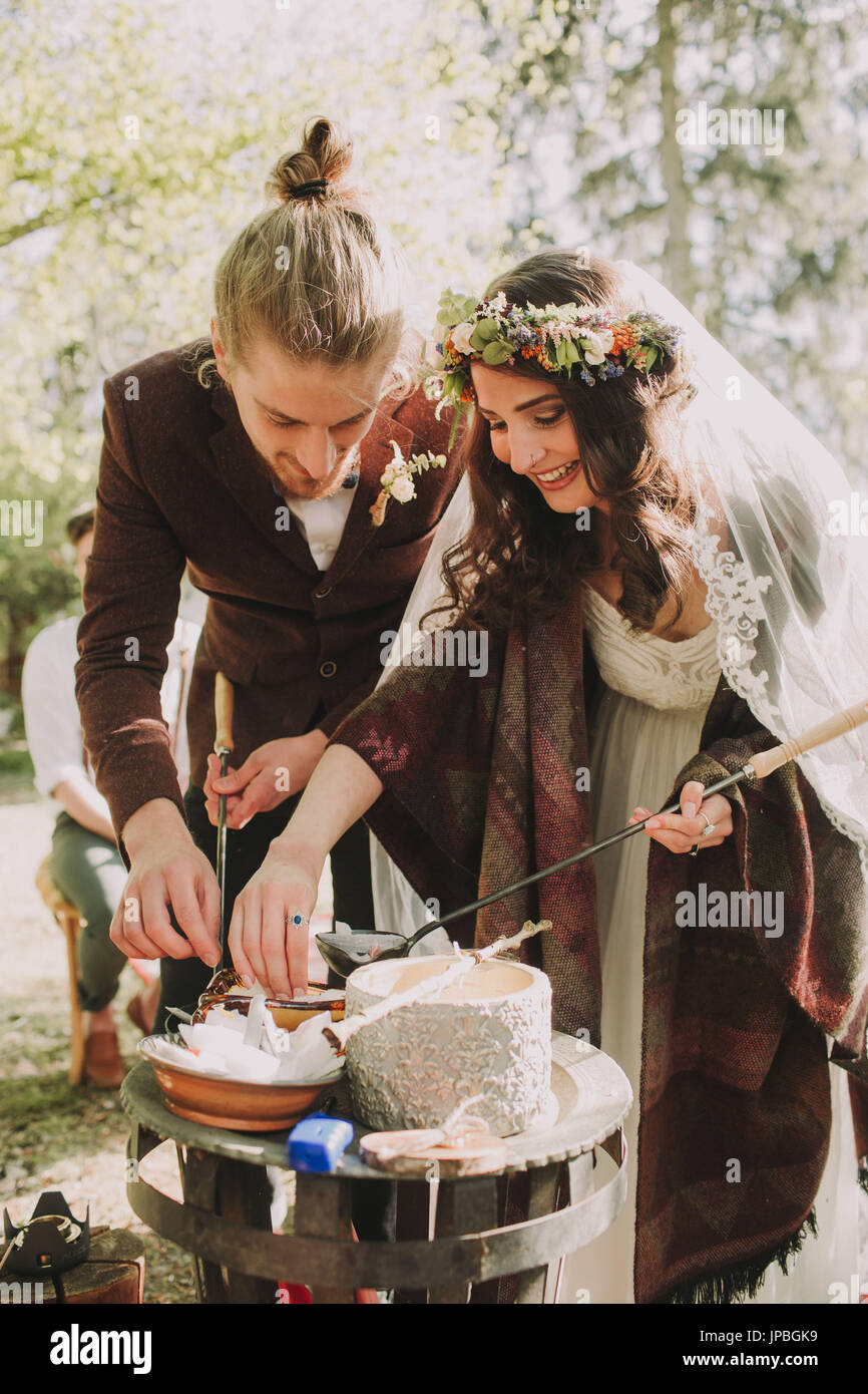 Alternate bridal couple at wedding ritual outdoors Stock Photo - Alamy