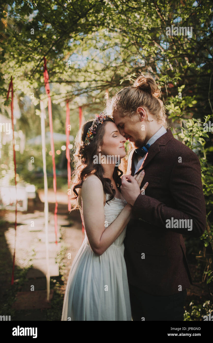 Bridal couple at alternative outdoor wedding, half profile Stock Photo ...
