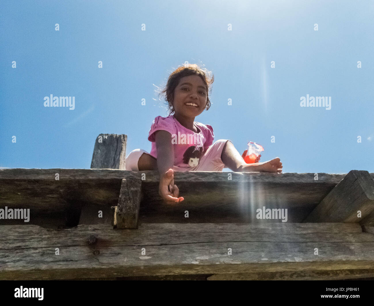 Young girl says good bye, Indonesia, Rinca, Kampung Rinca, boardwalk ...