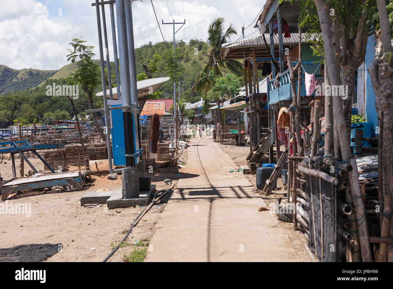 Main road of Kampung Rinca with new power line in town, town, Indonesia ...