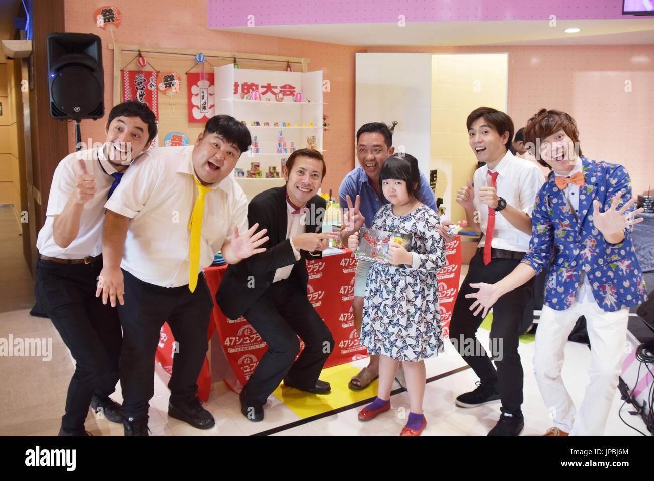 Japanese comedians pose for a photo with visitors at the "Kawaiian Cafe ...