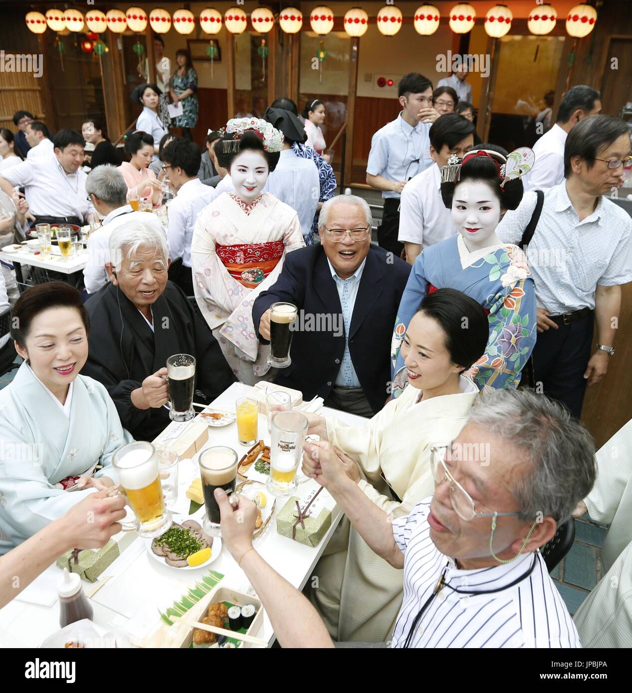 Geisha entertain customers at a beer garden in the ancient Japanese ...