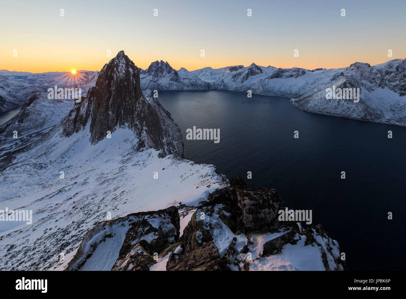 View of Mount Segla and frozen sea along the Mefjorden from peak Hesten ...