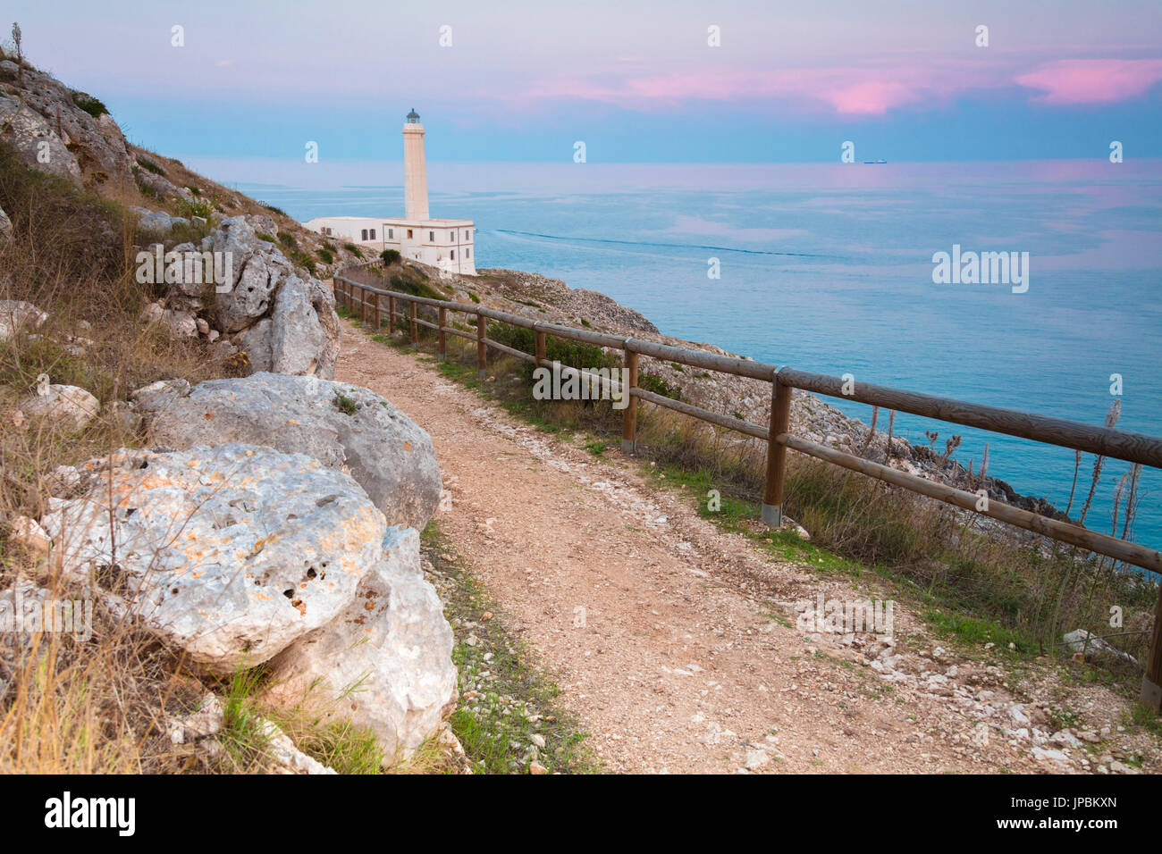 Pink sky on turquoise sea frames the lighthouse at Punta Palascia at ...