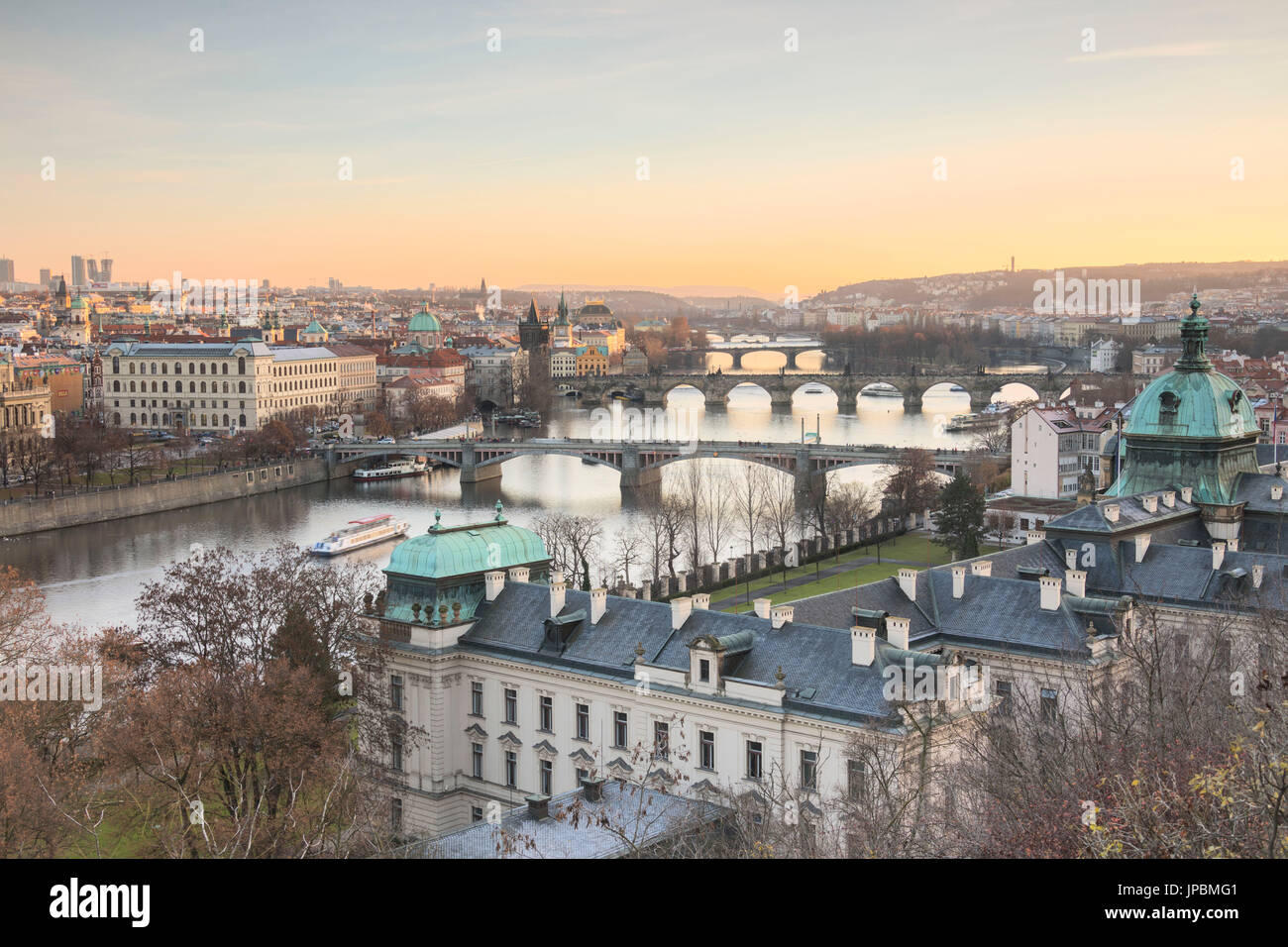 Sunset on the historical bridges and buildings reflected on Vltava ...