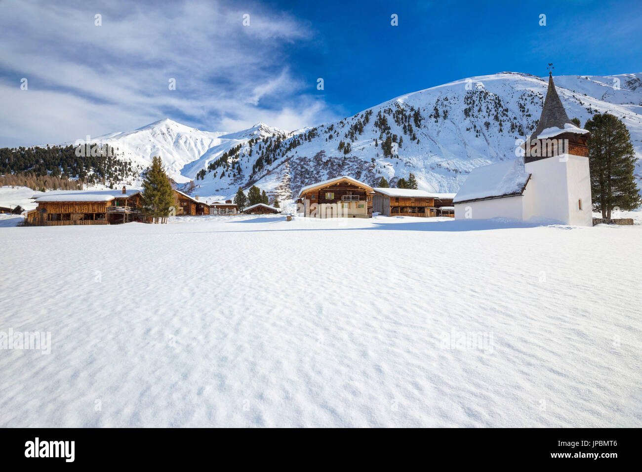 Walser houses and the white typical church of Sertig Dorfli. Sertigtal ...